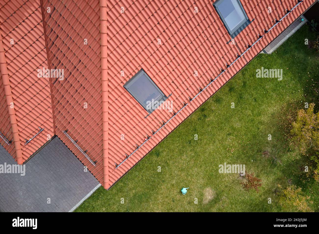 Closeup of attic windows on house roof top covered with ceramic ...