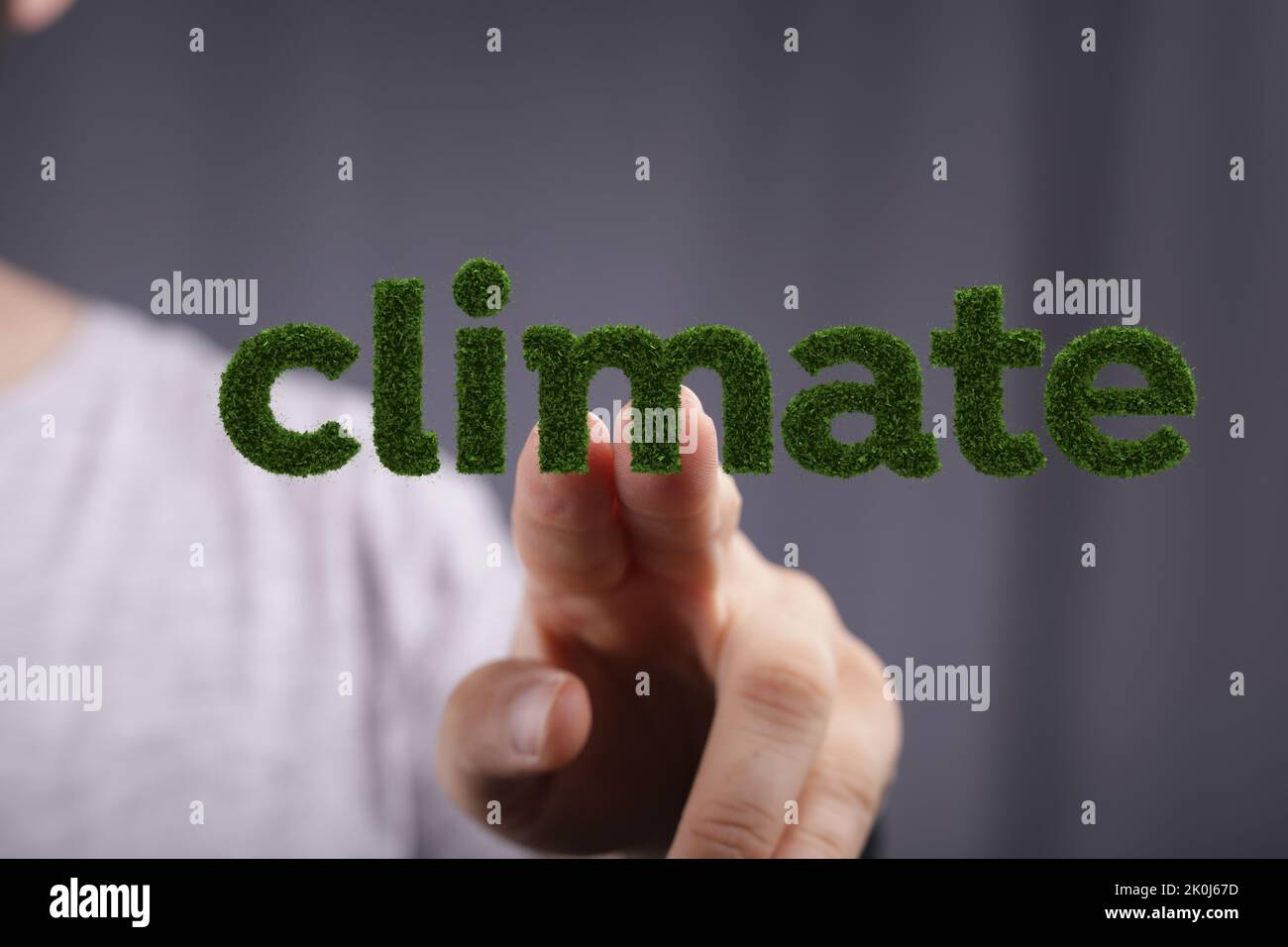 A man reaching for the illustrated green word "climate Stock Photo - Alamy