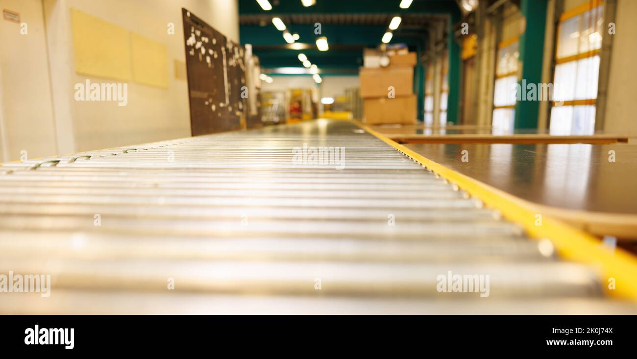 An empty industrial roller conveyor belt in a fully automated factory ...