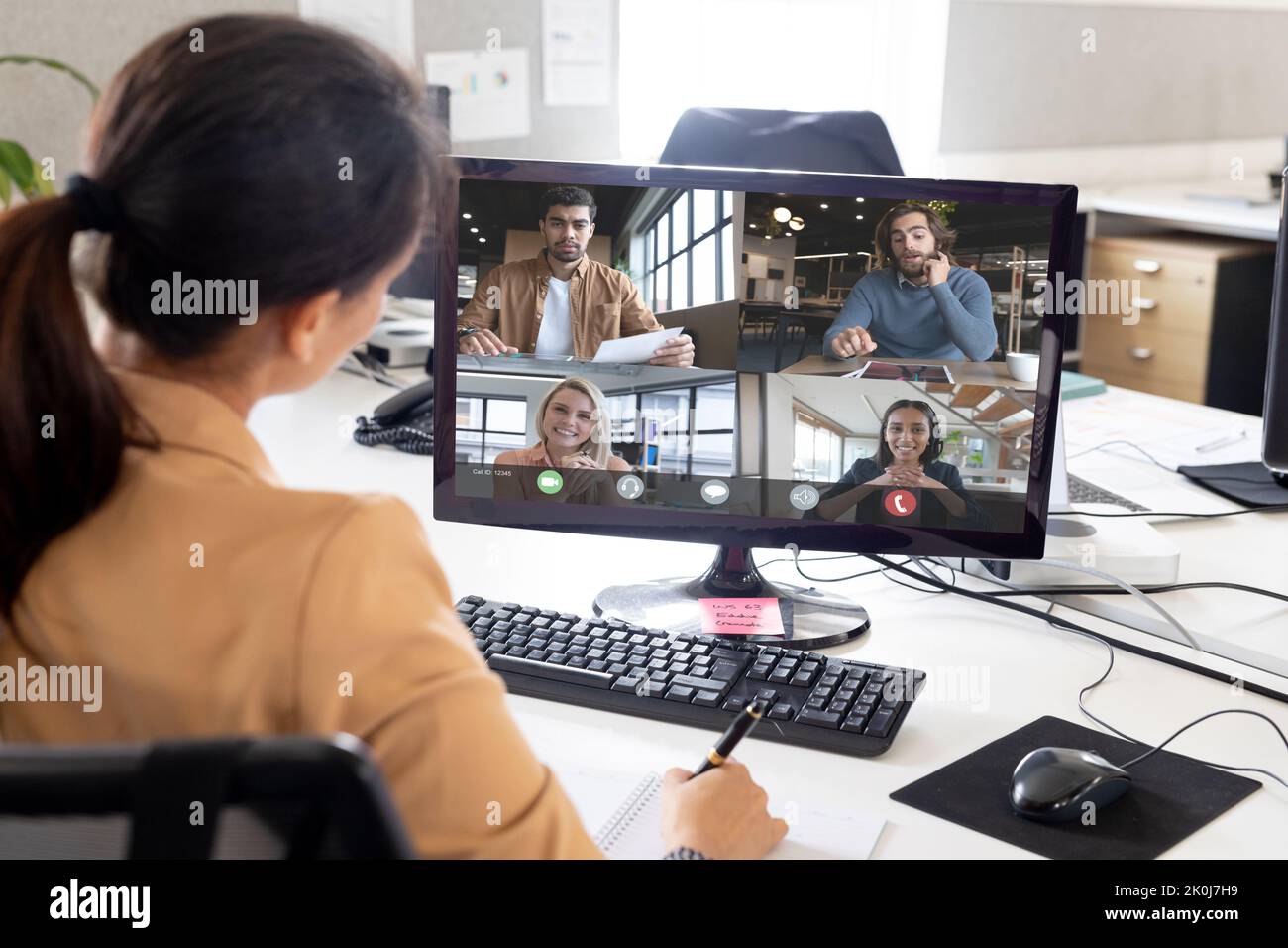 Over shoulder view of asian businesswoman making video call with ...