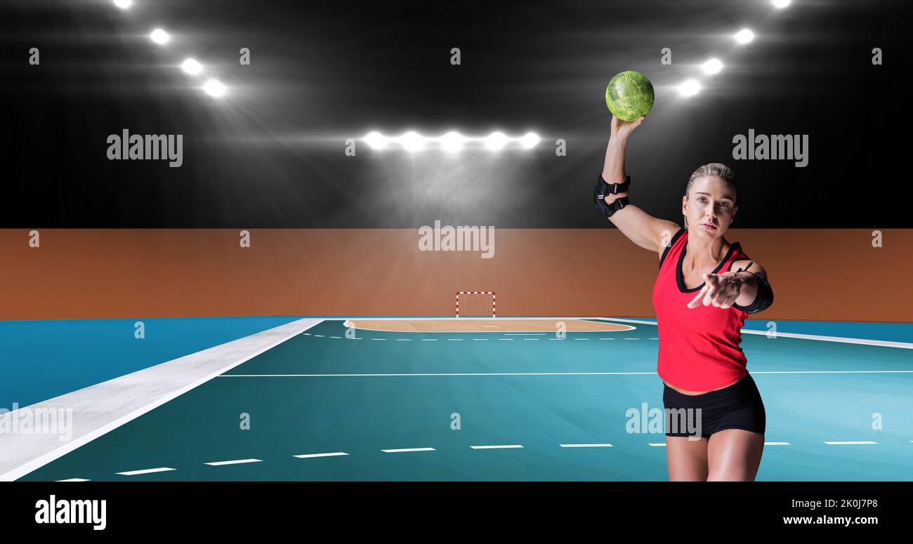 Portrait of muscular female caucasian handball player throwing ball at ...