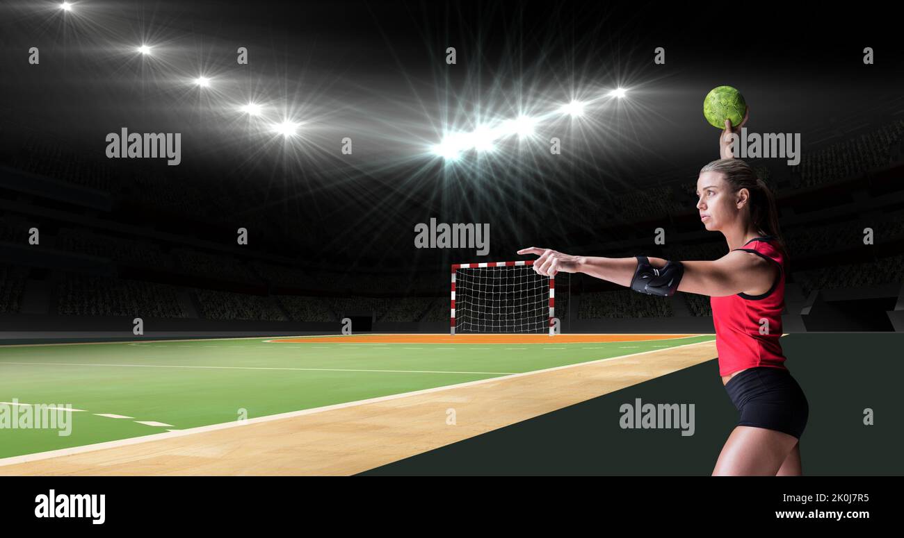 Caucasian female handball player pointing away while holding ball at ...