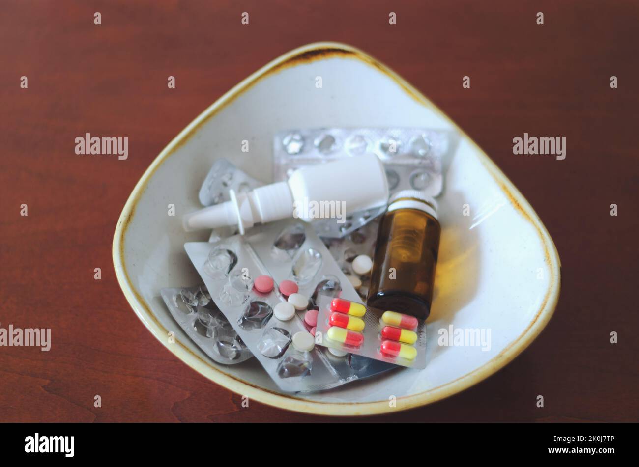 Many pills, drops in the nose, packages and blisters with pills lie in ...