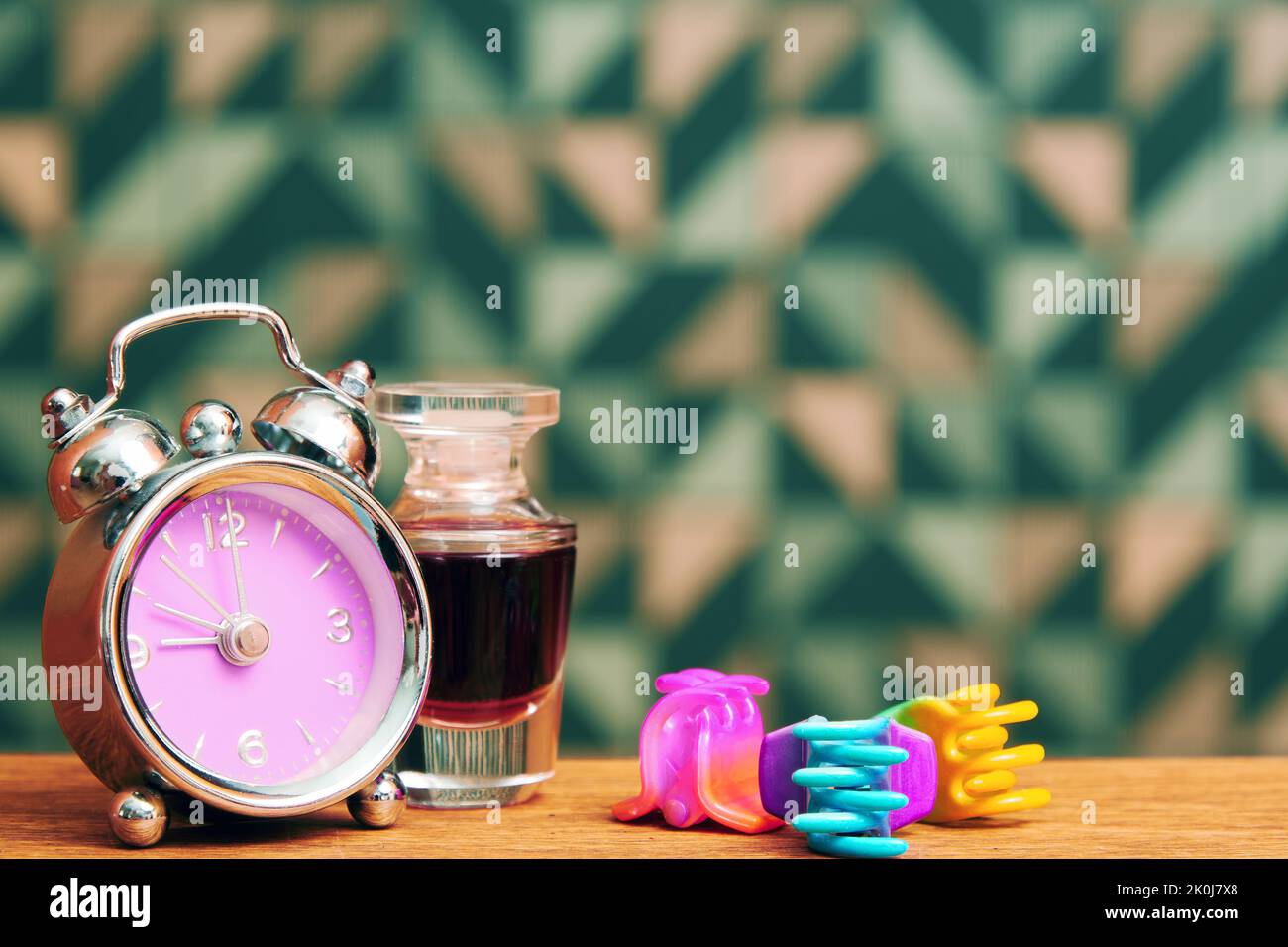 Blue toned bed table with fancy clocks and perfume for girl. Perfume ...