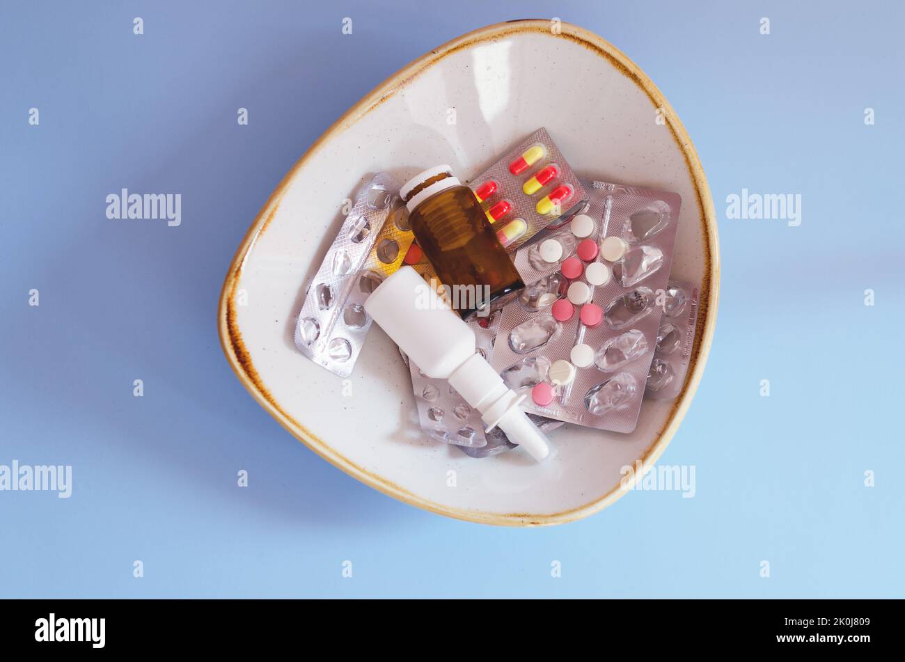 Many pills, drops in the nose, packages and blisters with pills lie in ...