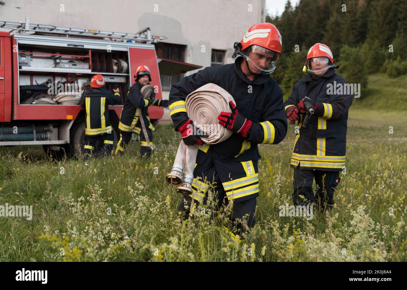 Group of fire fighters standing confident after a well done rescue ...