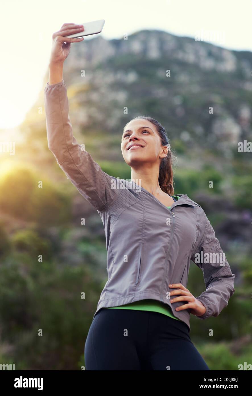 Remember this moment. a young woman taking a selfie while out for a ...