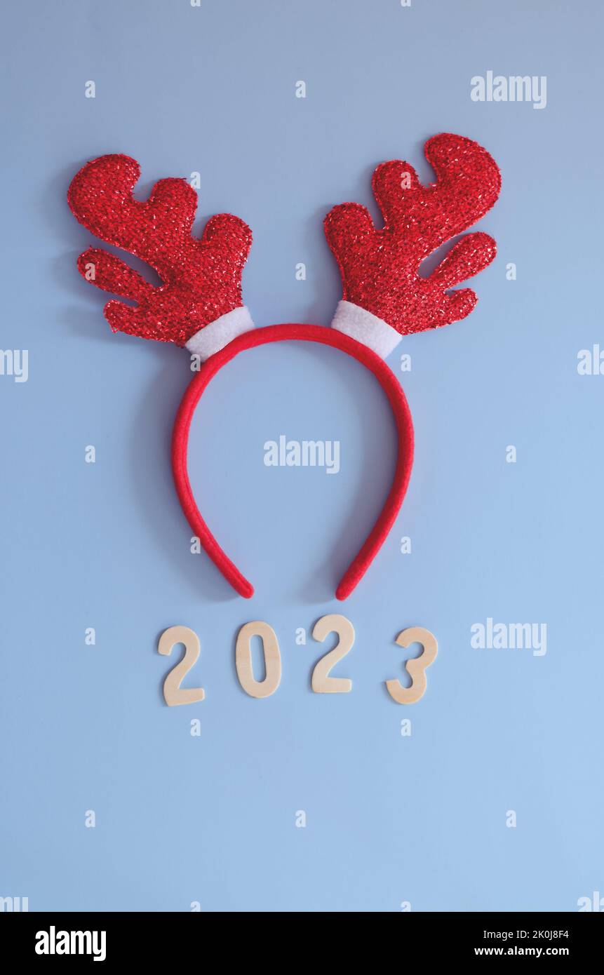 Top view of numbers 2023. Red cartoon deer horns close up. Blue ...
