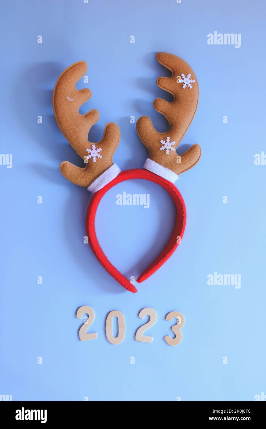 Top view of numbers 2023. Red cartoon deer horns close up. Blue ...