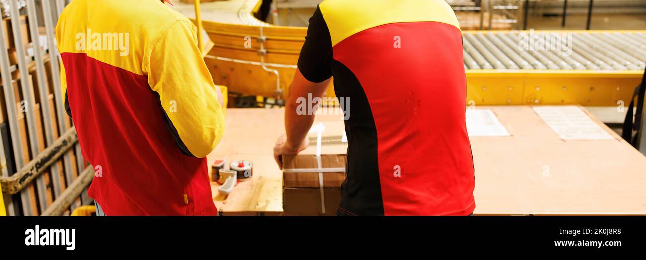 Two men packing a boxes in a warehouse Stock Photo - Alamy