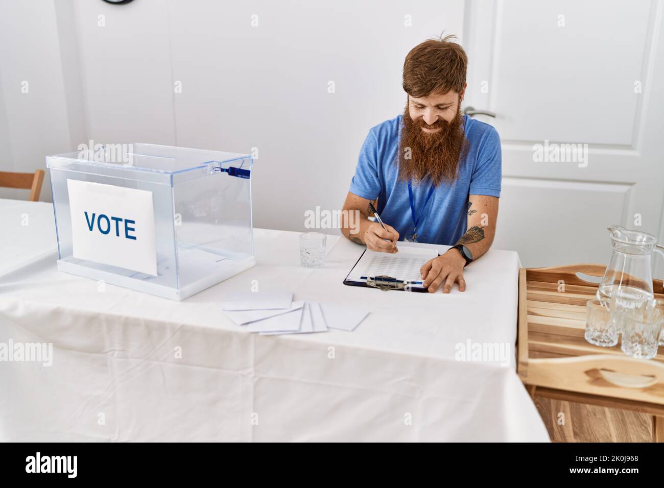 Young redhead politic party worker smiling happy working at electoral ...