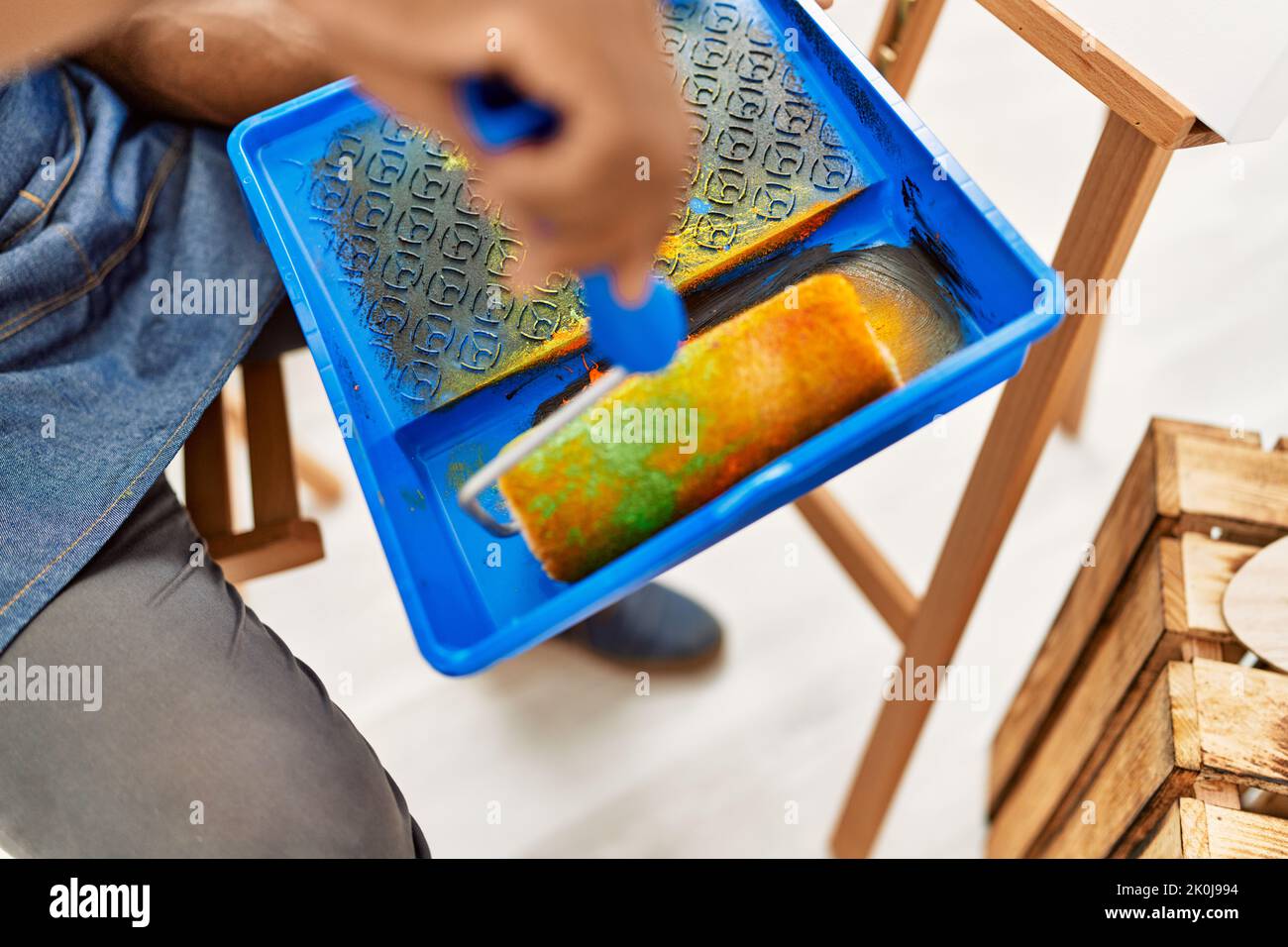 Hand of african american artist man drawing using paint roller at art ...