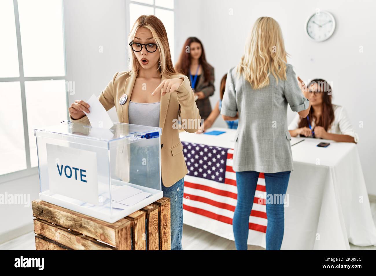 Group of young girls voting at democracy referendum pointing down with ...