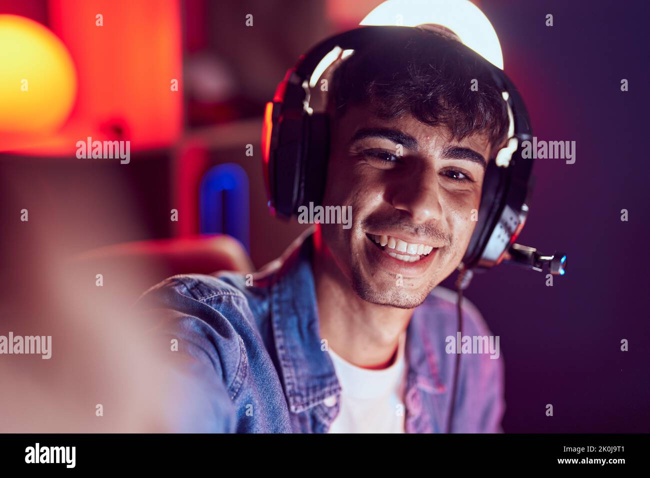 Young hispanic man streamer smiling confident make selfie by camera at ...
