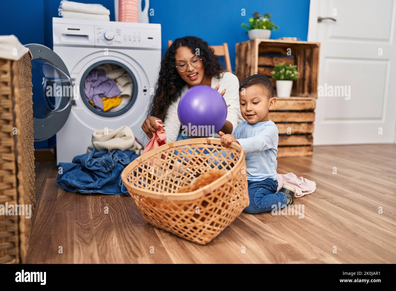 Mother and son smiling confident washing clothes at laundry room Stock ...
