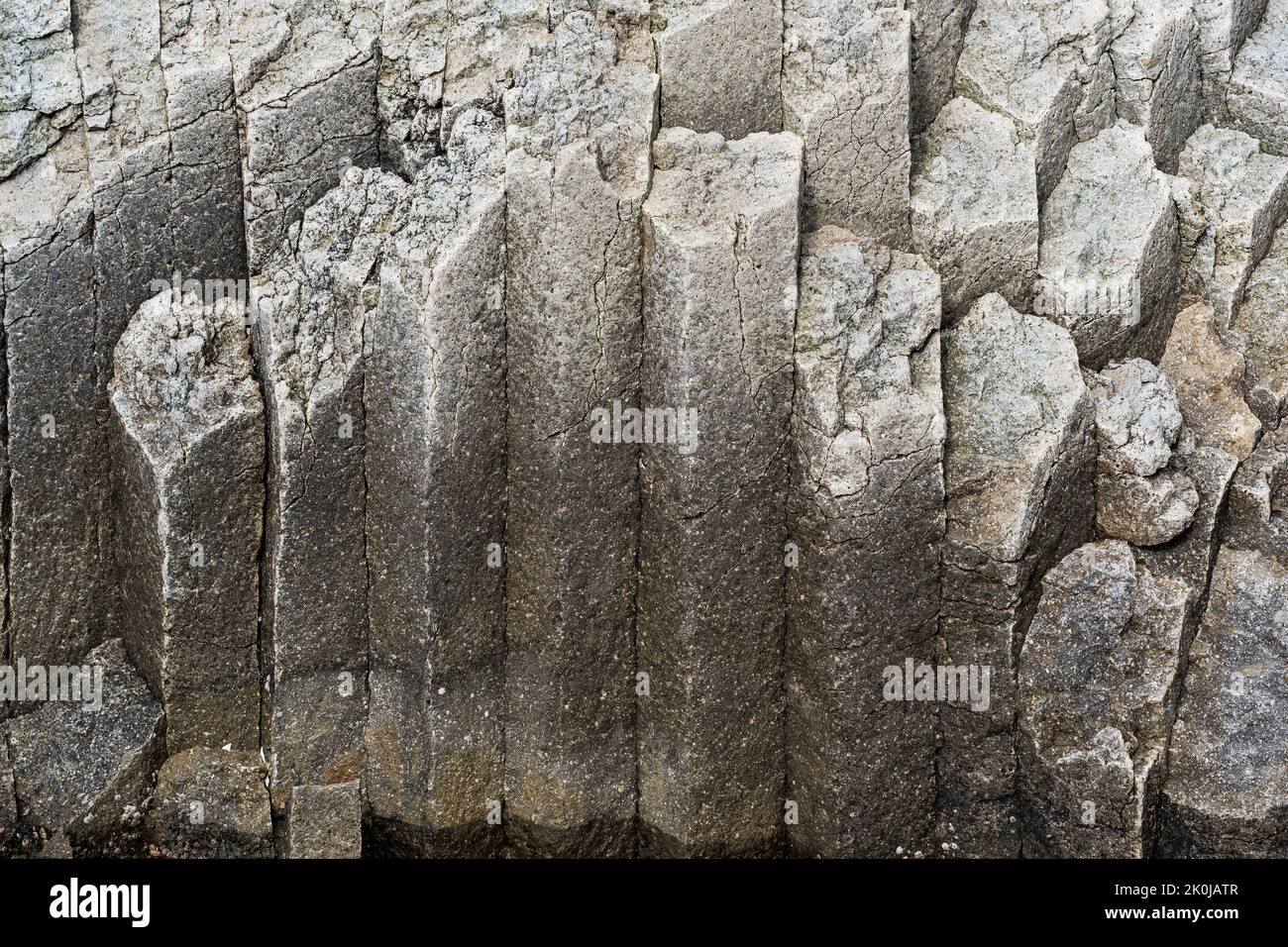 natural background, the surface of a volcanic coastal rock from basalt ...
