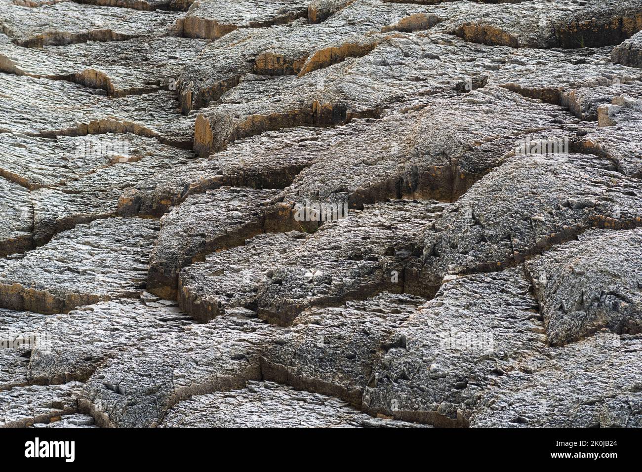 natural stone background, the remains of lava basalt columns form a ...