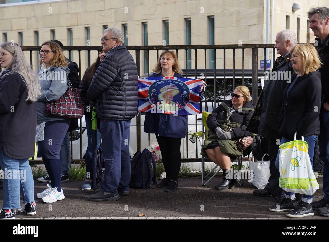 People queue at the Meadows in Edinburgh to obtain a wrist band ...