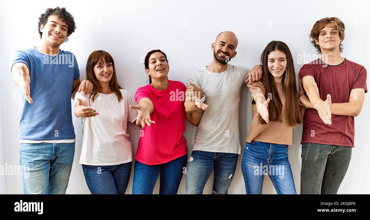 Group of young friends standing together over isolated background ...