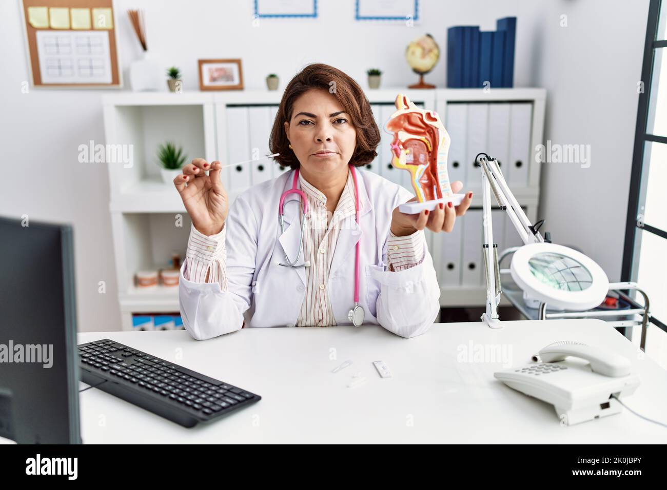 Middle age hispanic doctor woman holding coronavirus infection nasal ...