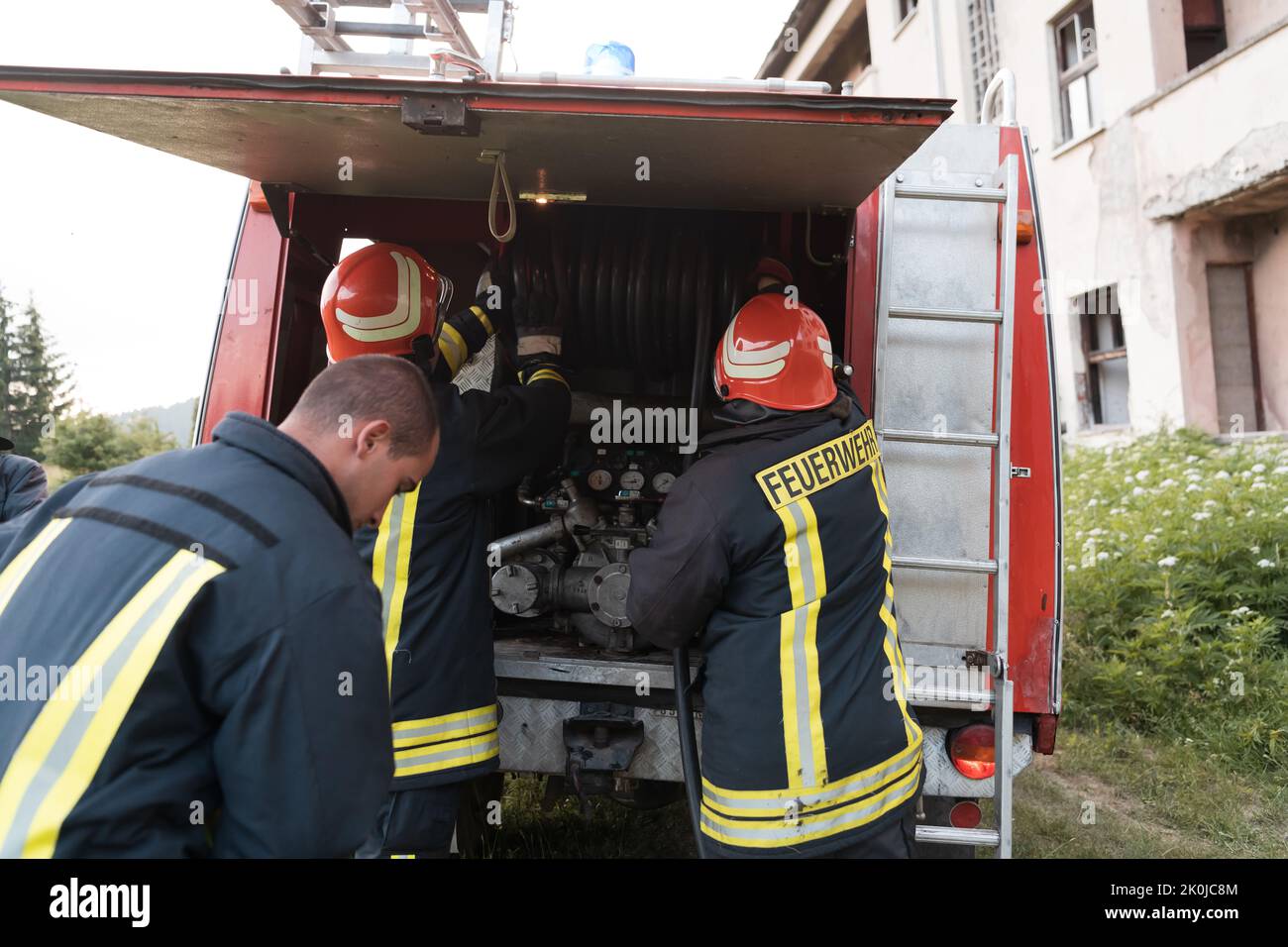 Group of fire fighters standing confident after a well done rescue ...