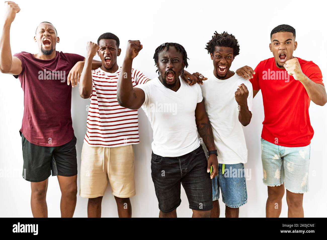 Young african group of friends standing together over isolated ...