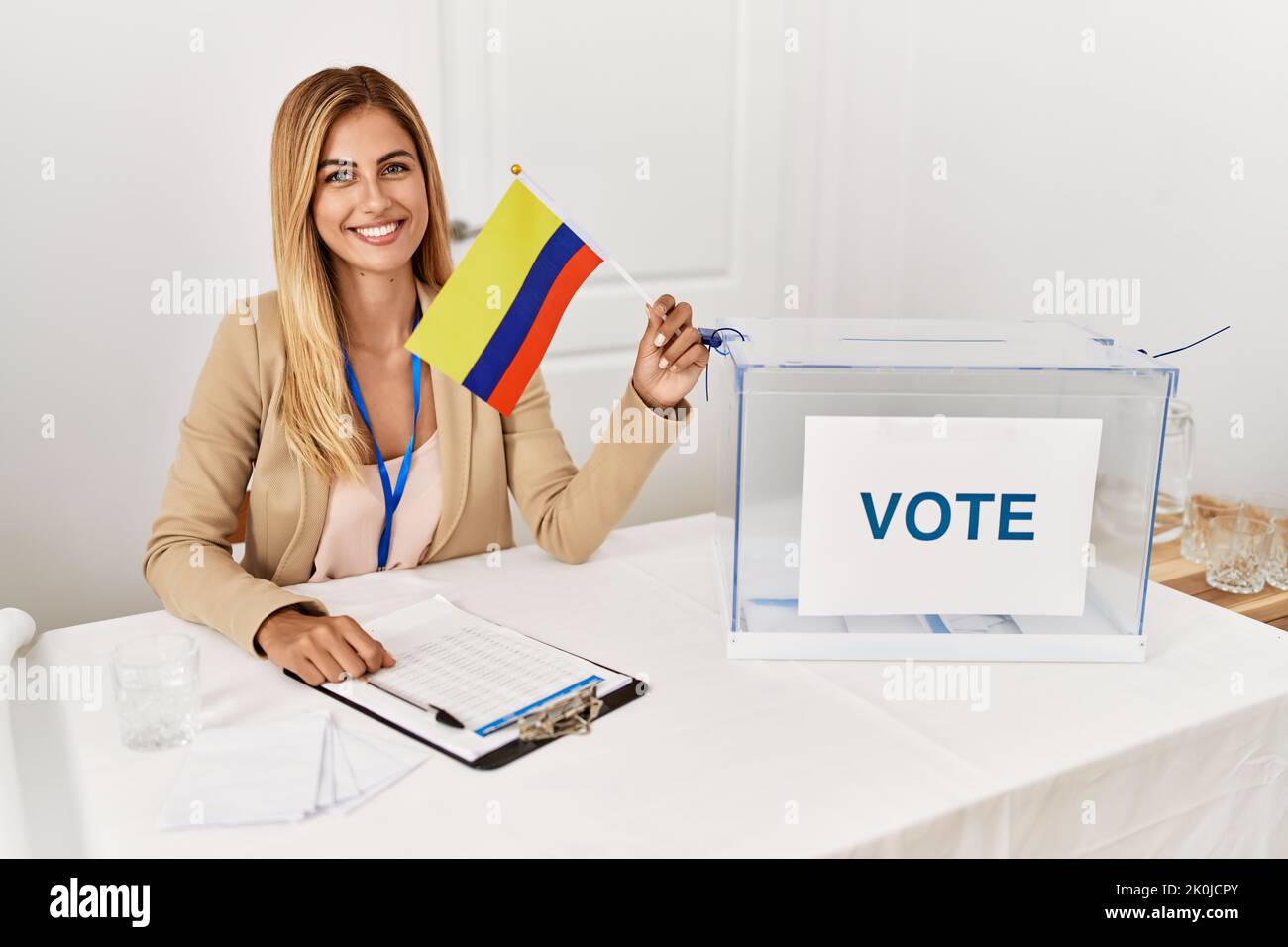 Blonde beautiful young woman at political campaign election holding ...