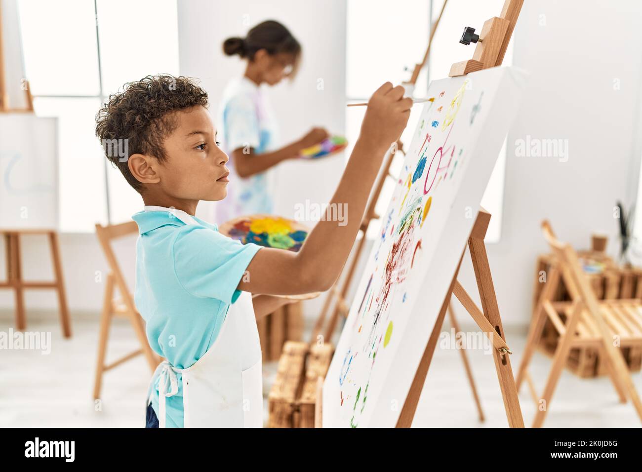 Brother and sister concentrate drawing at art studio Stock Photo - Alamy