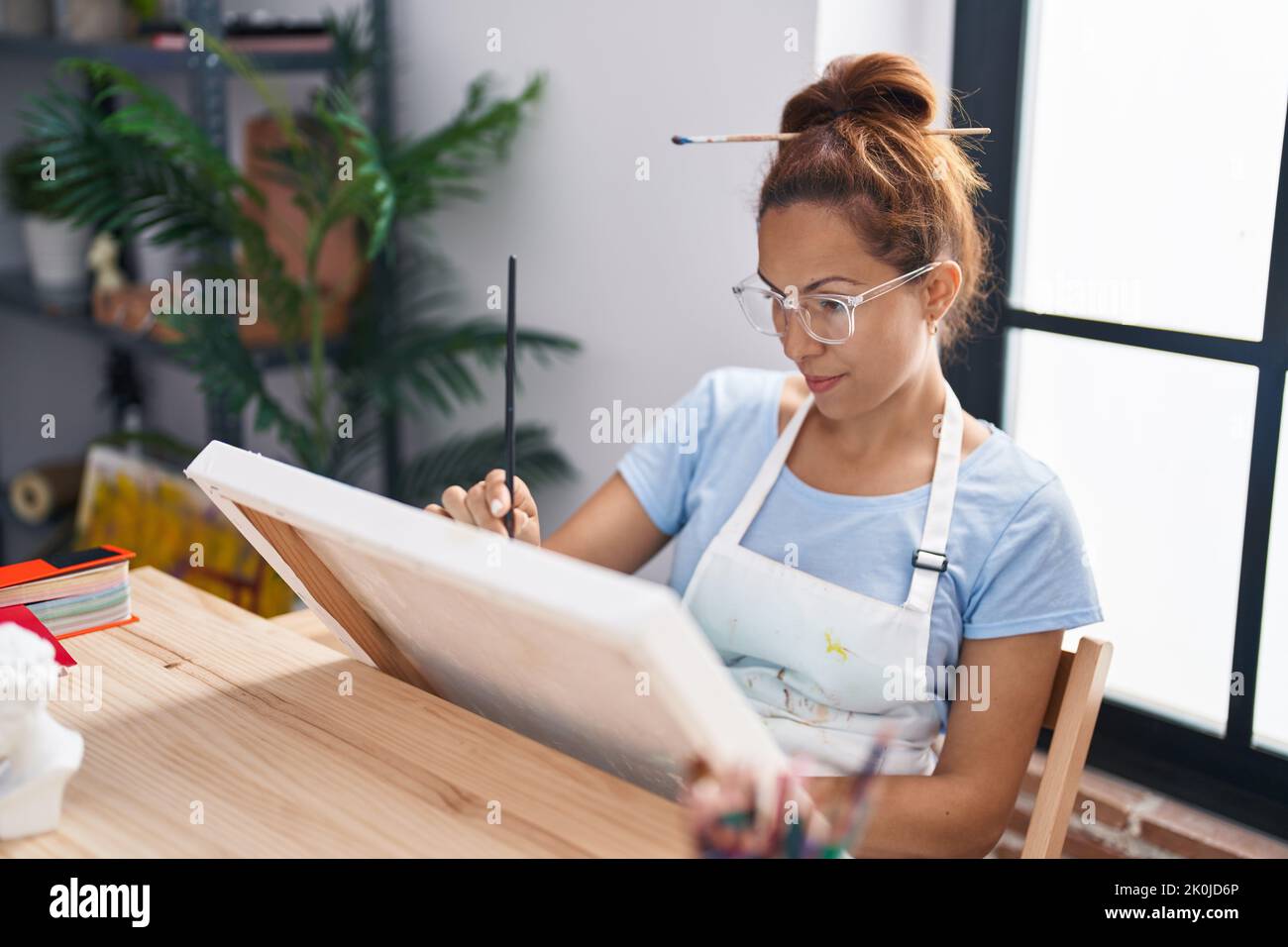 Young woman artist drawing at art studio Stock Photo - Alamy