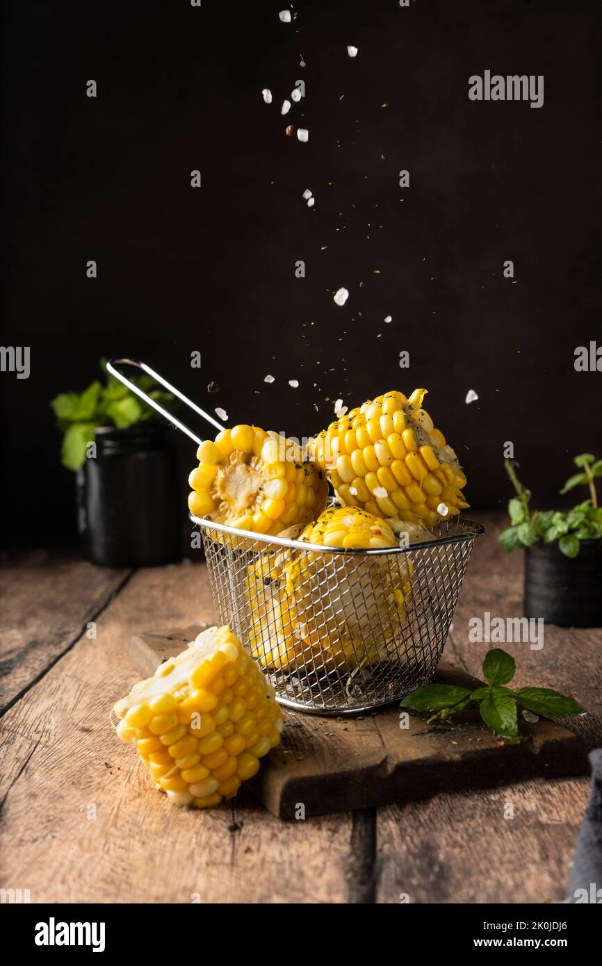 boiled corn cob. with salt and spices. vertical image. for advertising ...