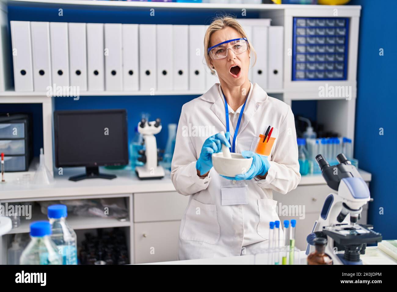 Skeptical young blonde scientist in hi-res stock photography and images ...
