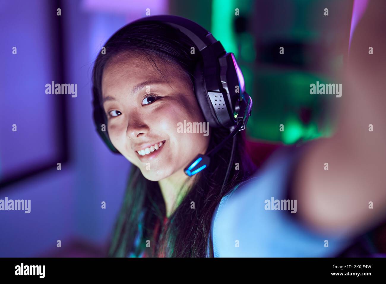 Young chinese woman streamer smiling confident make selfie by camera at ...