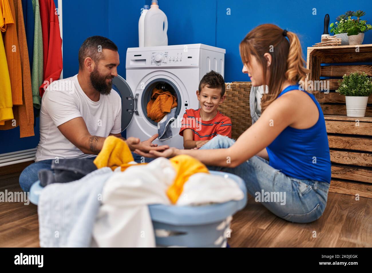 Family playing game washing clothes at laundry room Stock Photo - Alamy