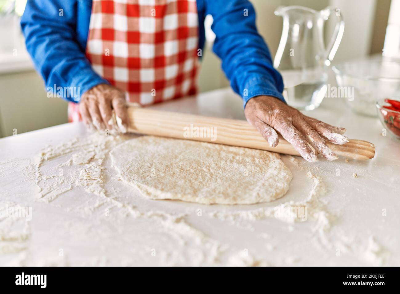 Senior man keading pizza dough at kitchen Stock Photo - Alamy
