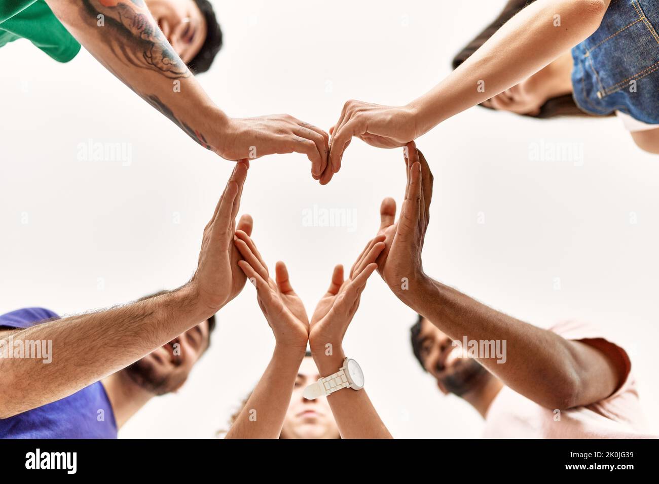 Group of young friends with hands together doing heart symbol Stock ...