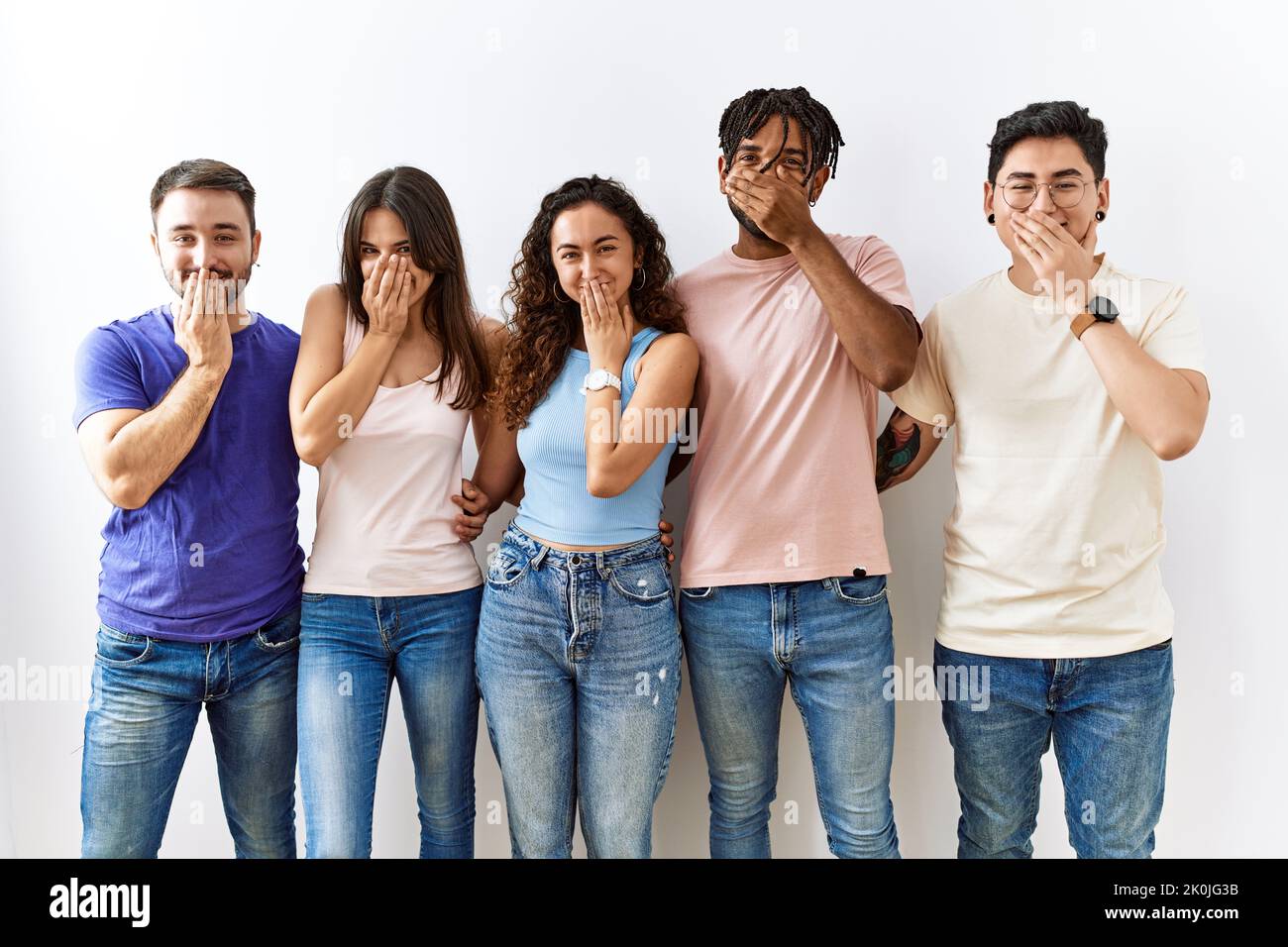 Group of young people standing together over isolated background ...