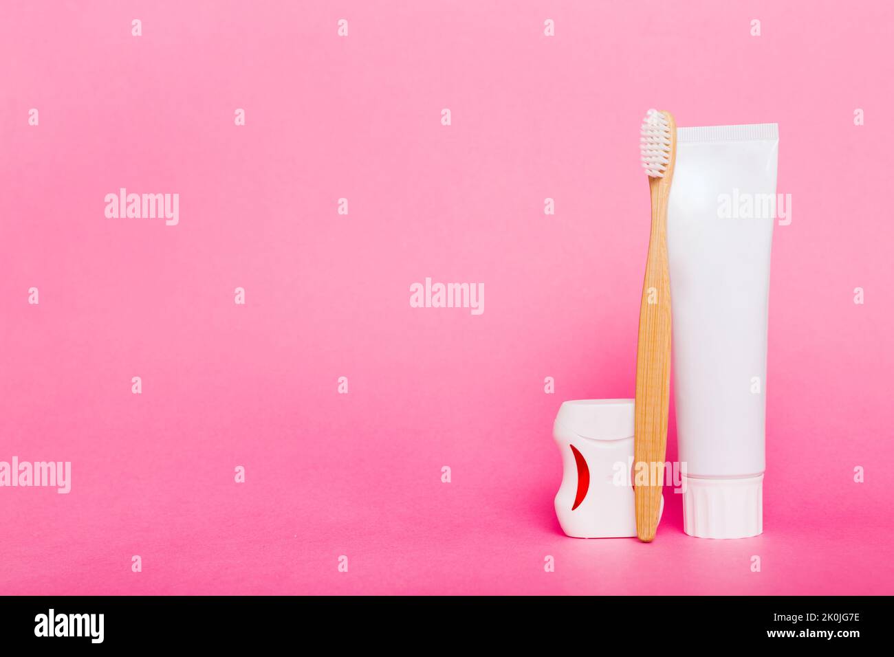 toothpaste and toothbrush top view with copy space on colored ...