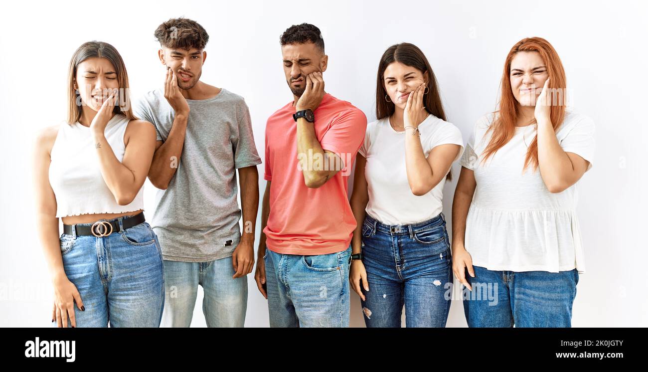Group of young friends standing together over isolated background ...