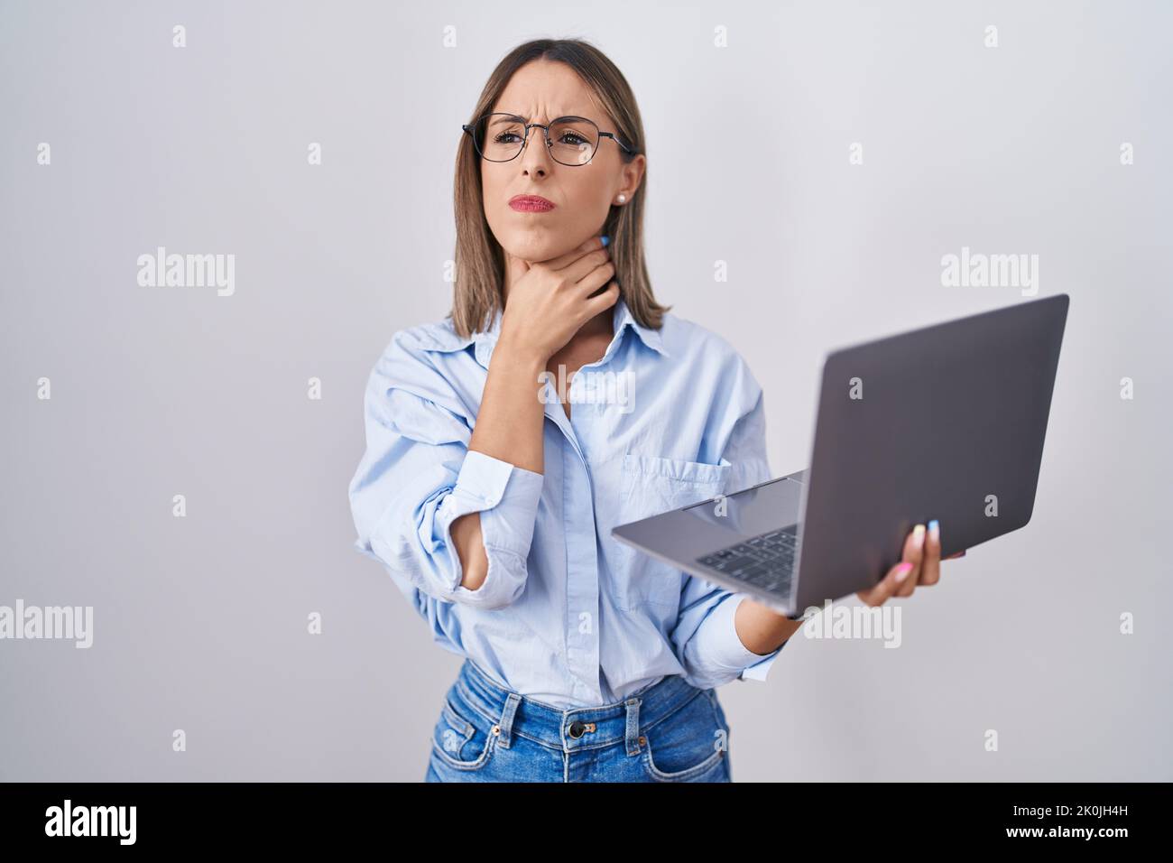 Young woman working using computer laptop touching painful neck, sore ...