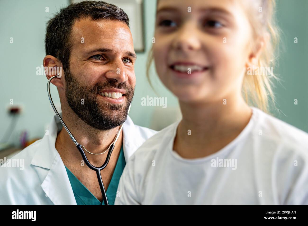 Doctor examines a child with stethoscope in examination room ...