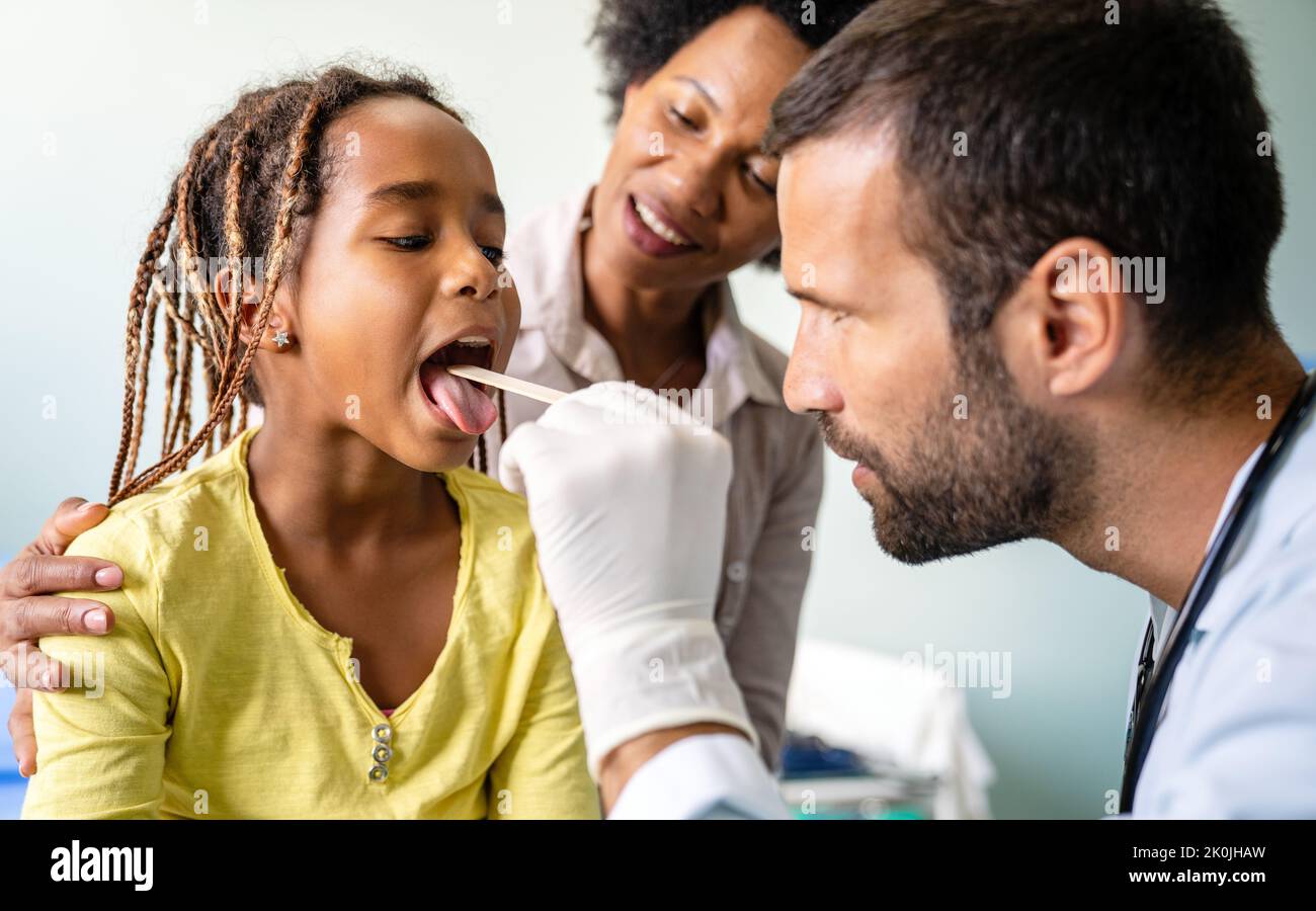 Young male pediatrician doctor examining child at office. Healthcare ...