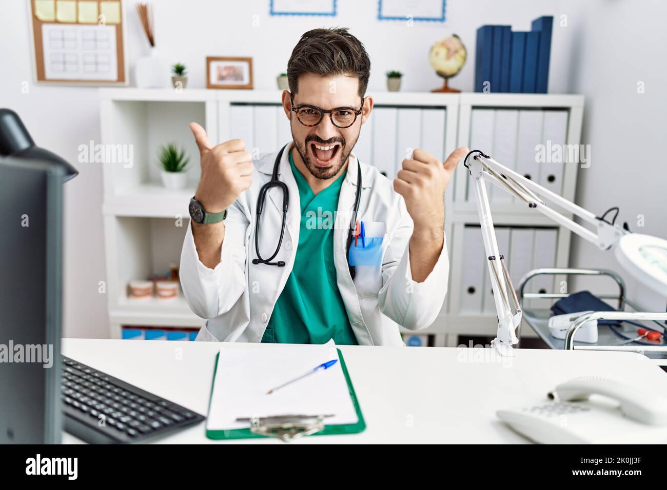 Young man with beard wearing doctor uniform and stethoscope at the ...