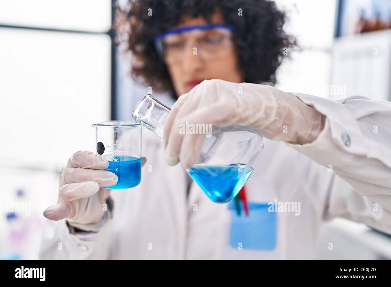 Young middle east woman scientist measuring liquid at laboratory Stock ...