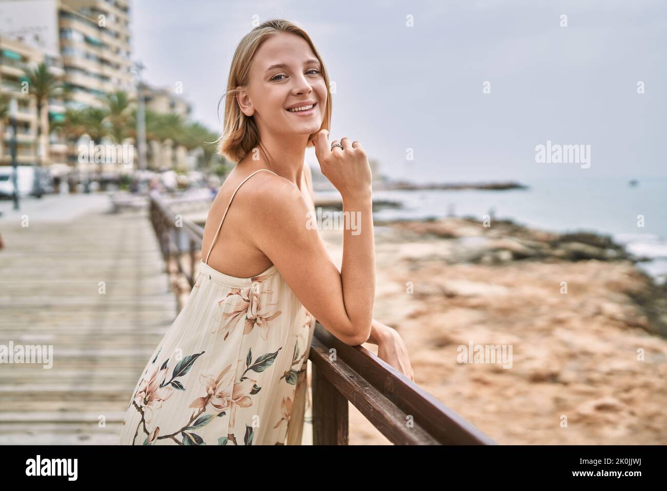 Young beautiful woman smiling confident by the sea Stock Photo - Alamy