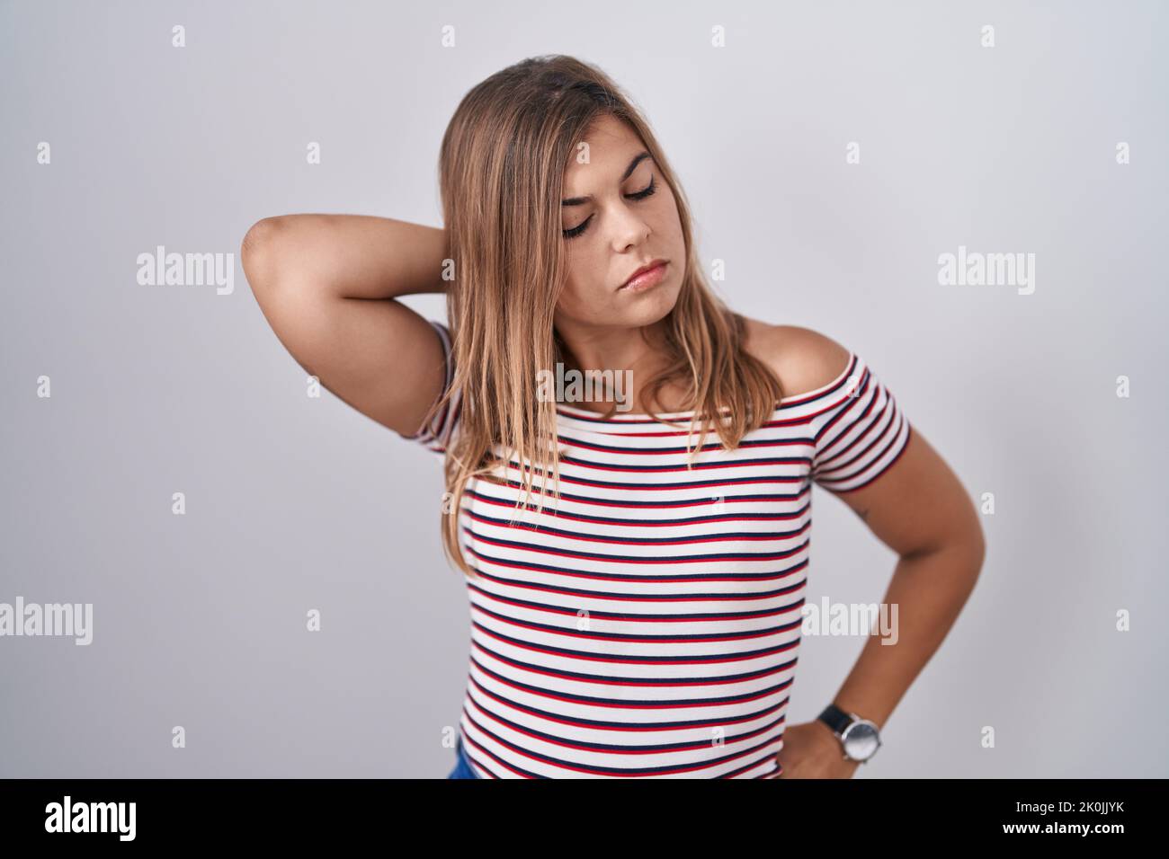 Young hispanic woman standing over isolated background suffering of ...
