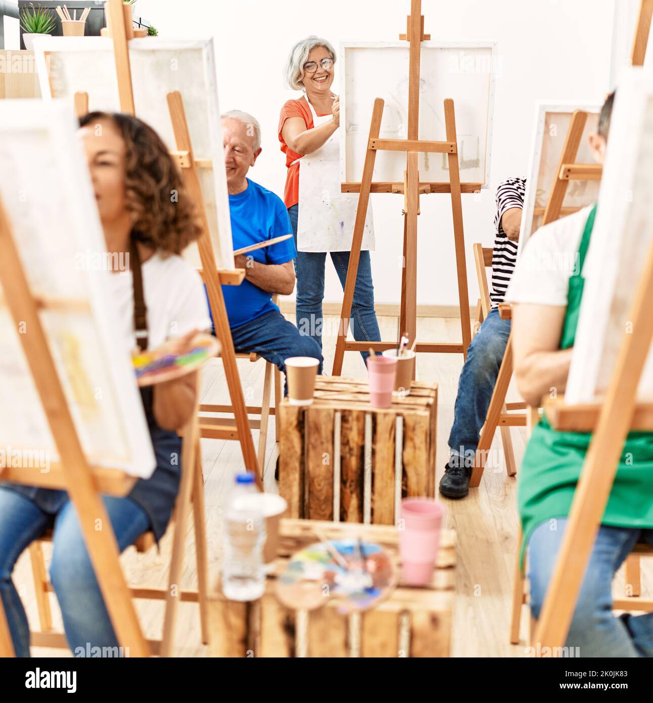 Group of middle age draw students smiling happy drawing at art studio ...