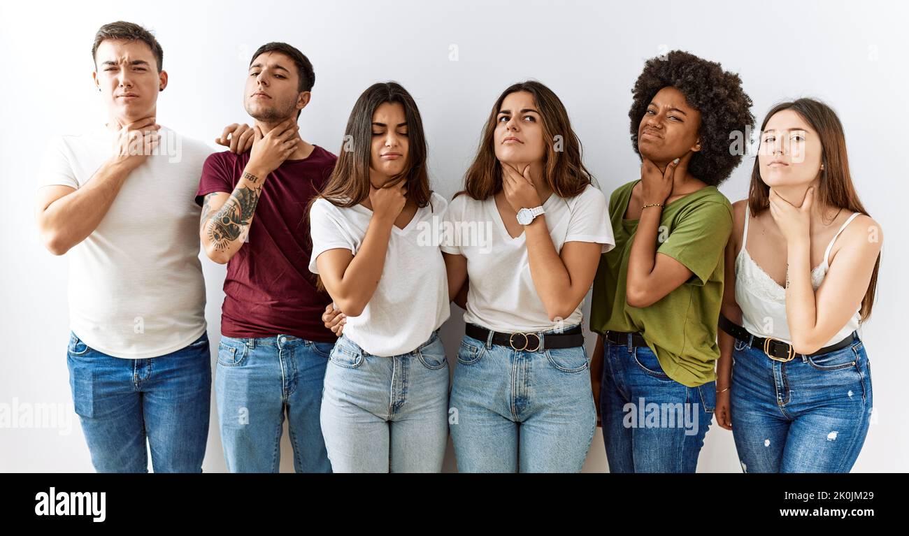 Group of young friends standing together over isolated background ...