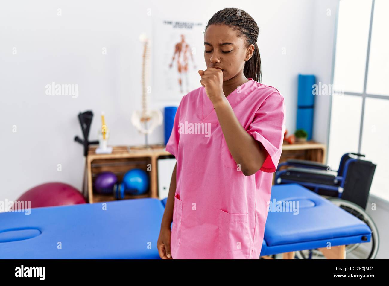 Young african american woman working at pain recovery clinic feeling ...