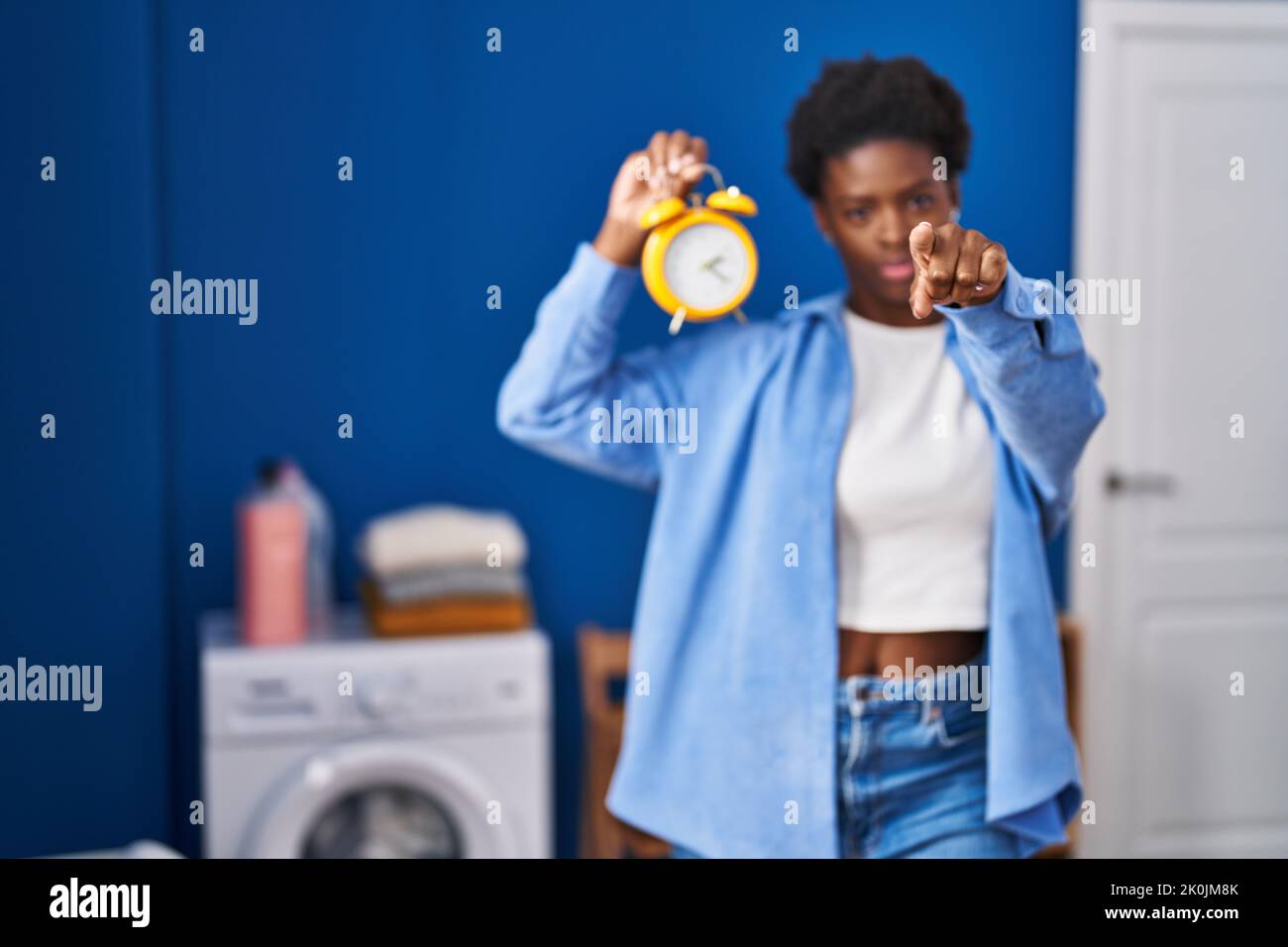 African american woman waiting for laundry pointing with finger to the ...