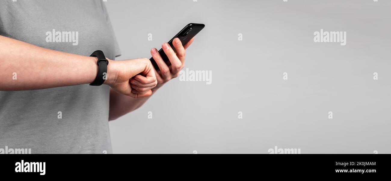 Banner with woman looking at fitness tracker app at phone and checking ...